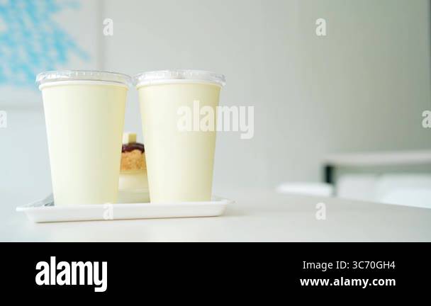 Selective focus hand picking up coffee cup at coffee shop. Asian female ...