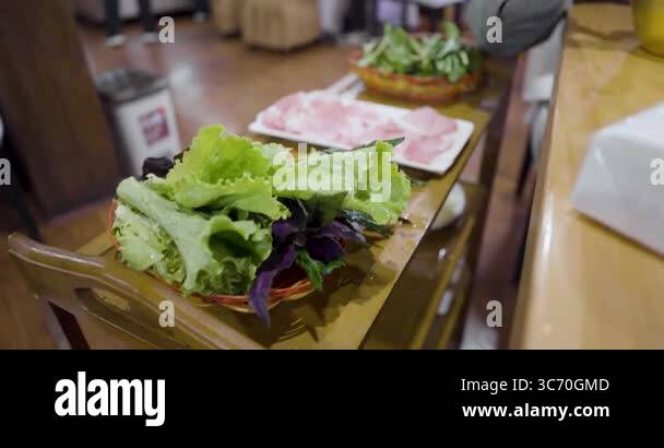 Close up image of vegetables and meat on plates at Yak hotpot ...