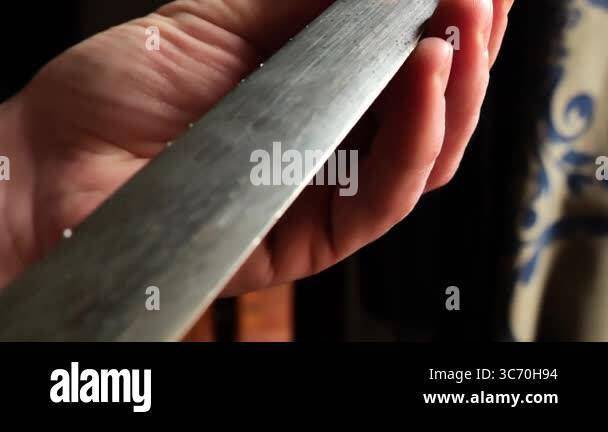 Dagger in hands. Steel blade in male hands on dark room background.Cold ...