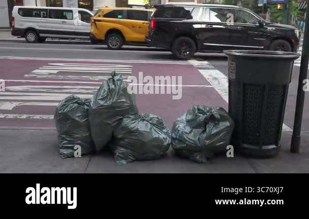 New York City, New York, USA - 07.29.2024: Garbage bags pile up on the ...