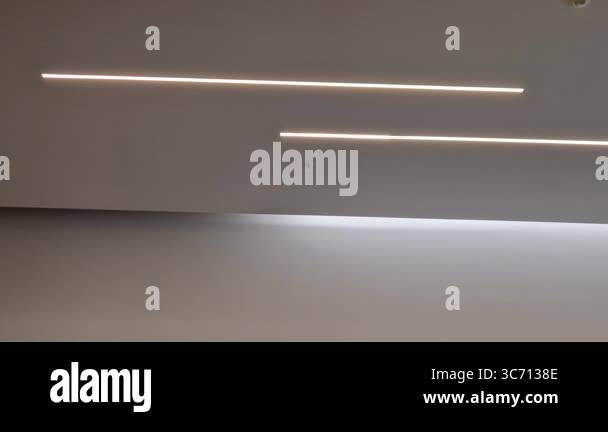 Strips of lights in the ceiling soffit. LED lights in a one-way dynamic ...