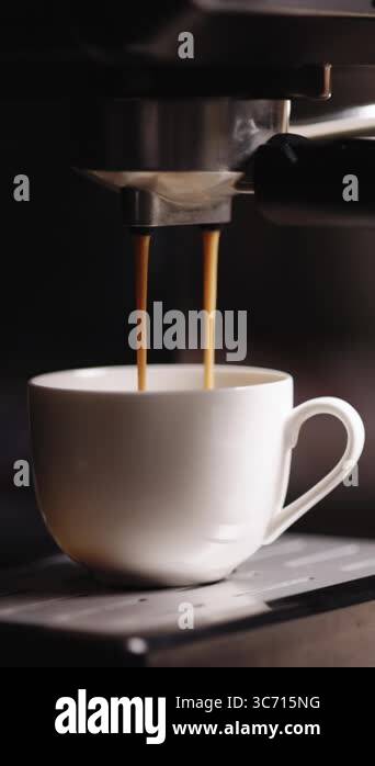 Vertical Video of Espresso machine making fresh coffee. Pouring coffee ...