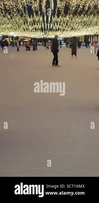 Kyiv, Ukraine, March 2, 2025:-Many people skating on white public ice ...