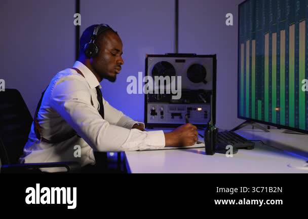 An African American intelligence officer listens to intercepted audio ...
