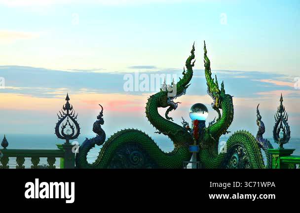 A stunning sunset view featuring intricately designed serpent statues ...
