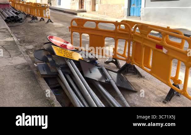 Preparations for urban road construction: stacked road signs and new ...