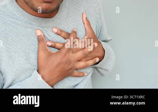 A person is experiencing chest discomfort with hands clutched tightly ...
