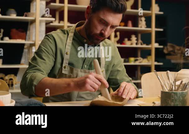 Working artist sculptor Caucasian man guy potter craftsperson ceramist ...