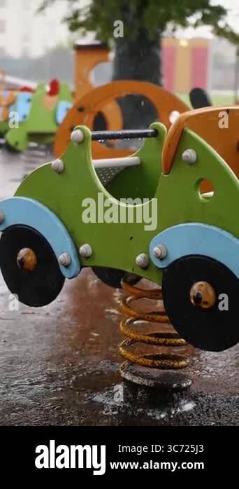 Rainy Day at Children's Playground with Colorful Spring Rider Stock ...