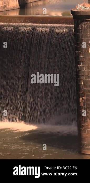 A dam near a big city. A dam with a waterfall of water. High quality 4k ...