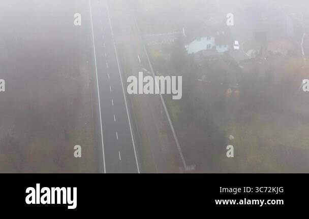 Dramatic aerial view of foggy mountain road Stock Video Footage - Alamy
