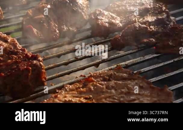 Rotate meat on a barbecue grill Stock Video Footage - Alamy