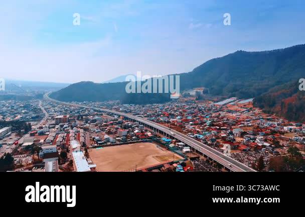 Long freeway crossing the highly populated area. Cityscape at the foot ...