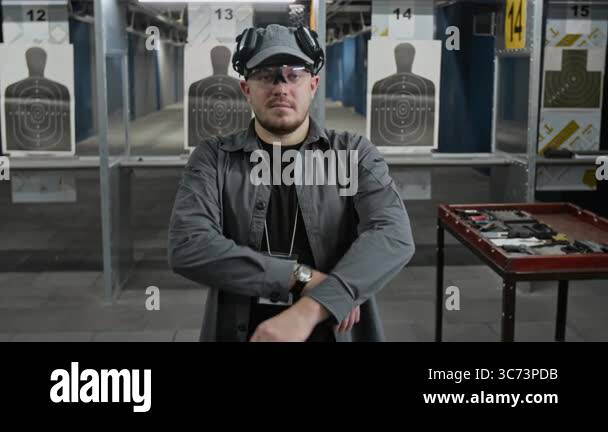 Medium portrait of young Caucasian male shooting range instructor or ...