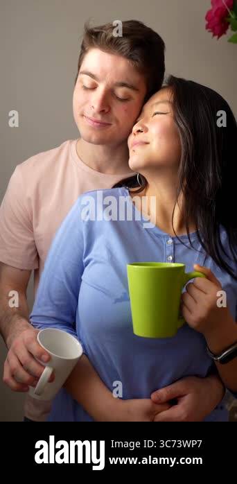 Multiethnic young couple sharing tender morning moments, drinking ...