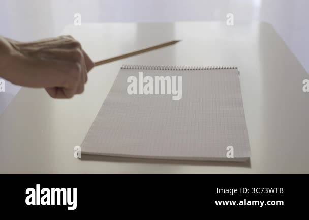 Put a pencil on notepad , white blank page and black pencil, place of ...