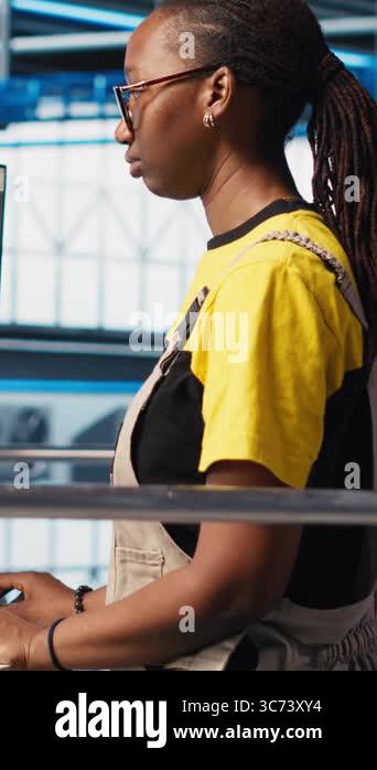 Vertical video Portrait of happy engineer in photovoltaics smart factory analyzing data ...