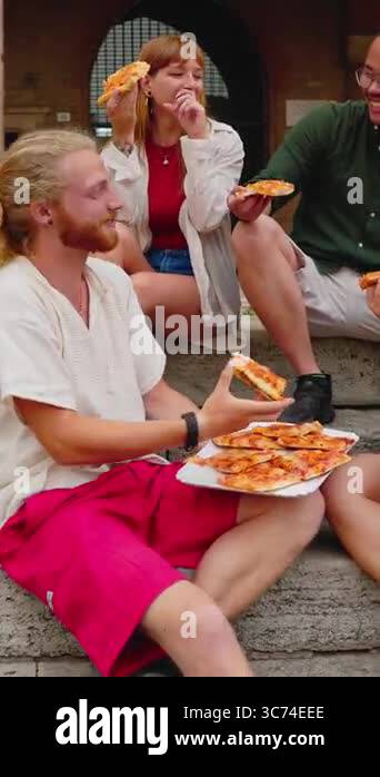 Vertical HD video of young diverse people eating margherita pizza at ...