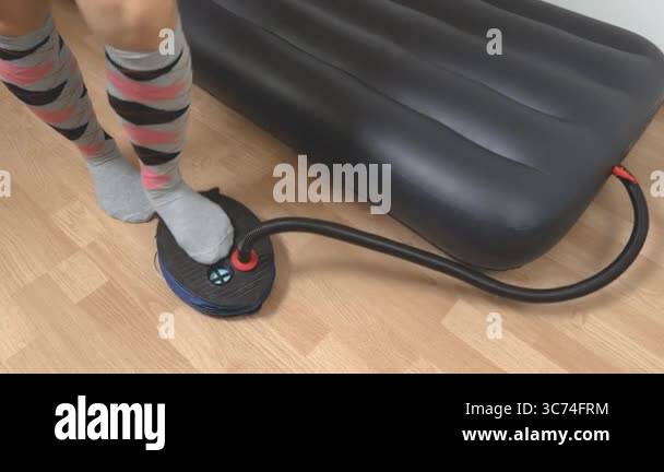 Person with an unrecognizable face with foot to fill air pump in ...