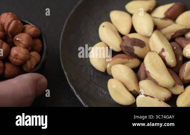 Brazil nut in a bowl, a food with selenium content. Useful vegan food ...