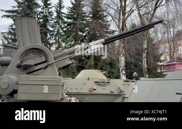 This is a closeup view of a heavy artillery gun that is mounted on a ...