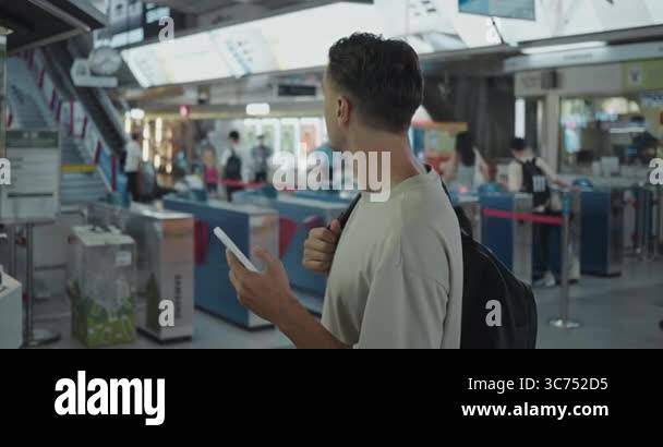 Man with smartphone in busy airport feeling unexpected flight delay ...