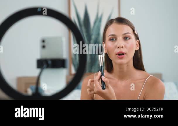 Young woman making beauty and cosmetic tutorial video content for ...