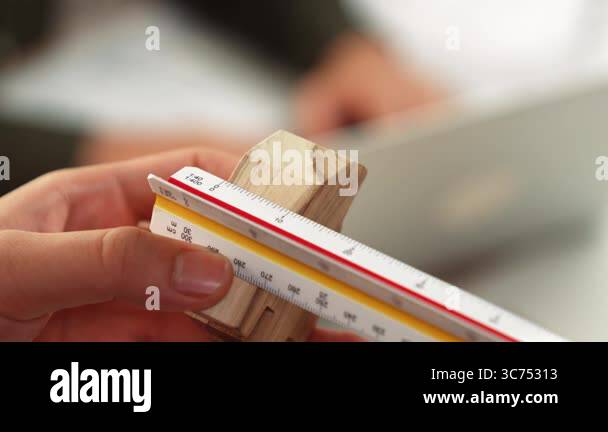 A video of skilled architect or safety engineer use scale ruler ...