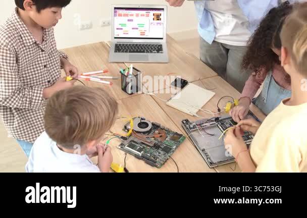 Group of diverse student working together on main board with laptop ...