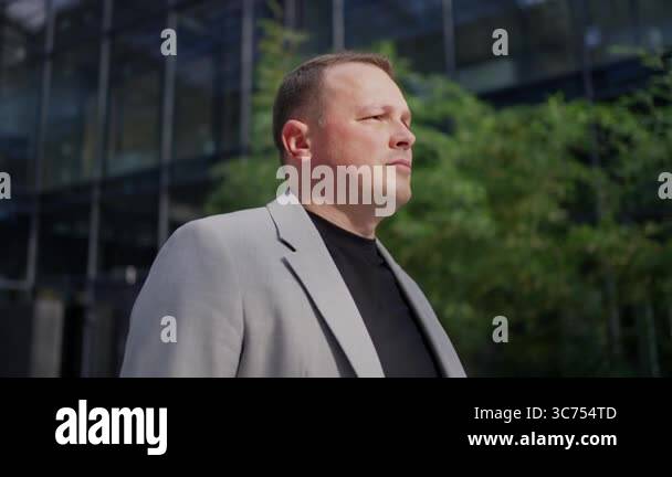 Capturing a moment of purposeful movement, this businessmans focused ...