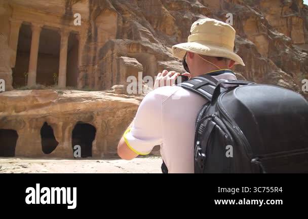 Tourist photographing ancient Jordan ruins in Little Petra, Jordan ...