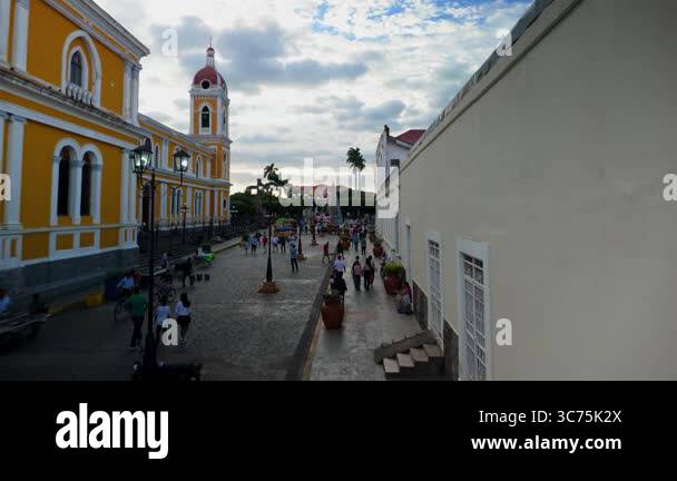Tourists and locals stroll down Calle La Calzada in Granada, Nicaragua ...