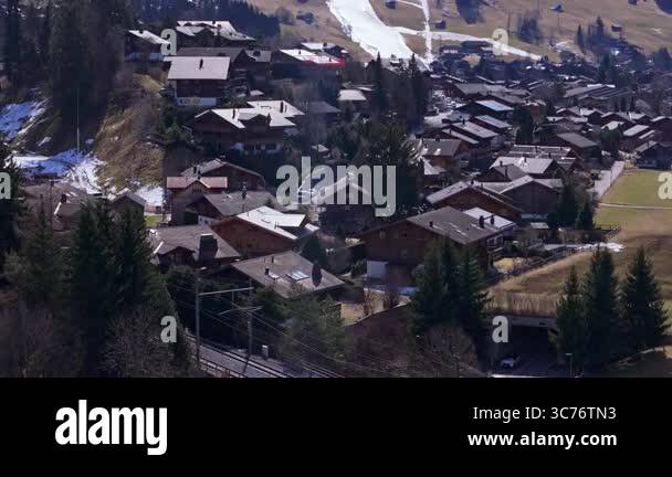Aerial view of Gstaad village in Swiss Alps, featuring traditional ...