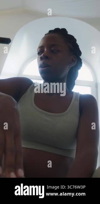 Vertical low angle shot of exhausted African American woman breathing ...