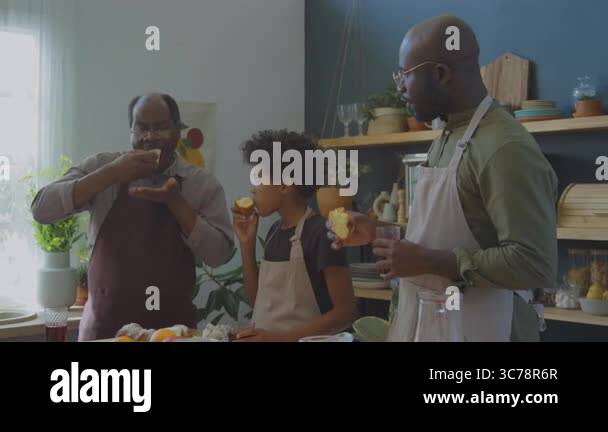 Multi-generational black family eating Meskouta cake and enjoying its ...