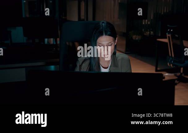 Female businesswoman employee working late in the office, using a ...