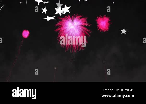 Bursting pink fireworks with white stars scattered in night sky ...