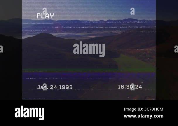 VHS-style animation overlaying date and time on mountain landscape ...
