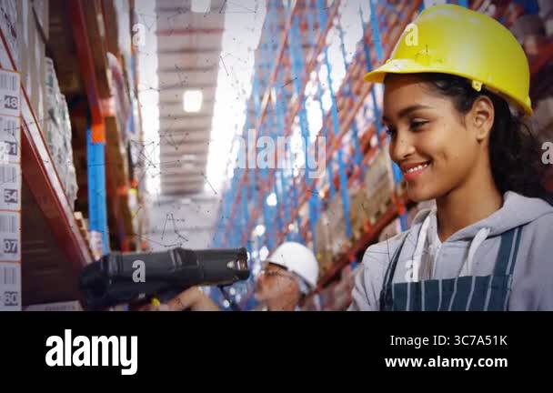 Scanning boxes with barcode scanner, warehouse worker wearing yellow ...