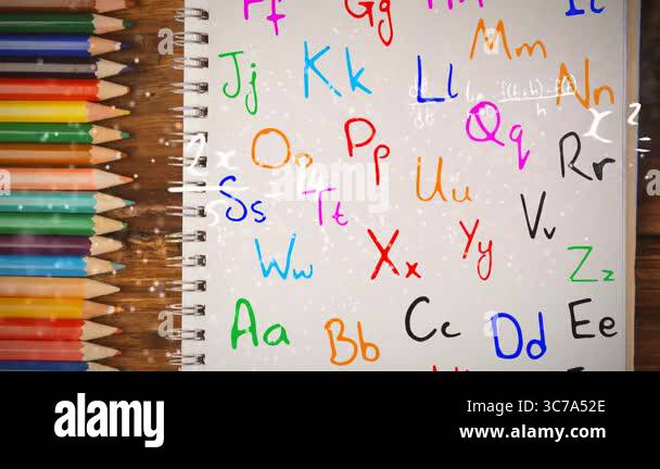 In school, colorful alphabet letters overlaying notebook with ...