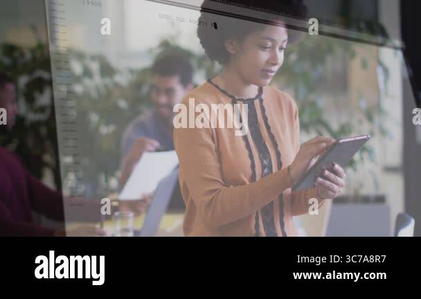 Using tablet with computer code overlay, woman in modern office ...