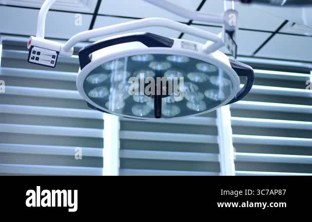 Modern round rotating lamp on the ceiling of the operating room ...