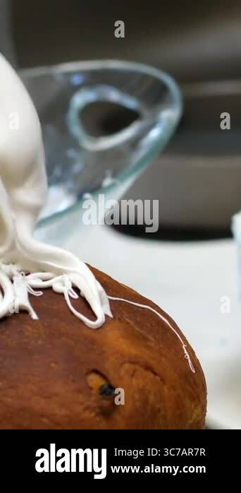 Close-up. A kitchen spatula smears icing on delicious Orthodox Easter ...