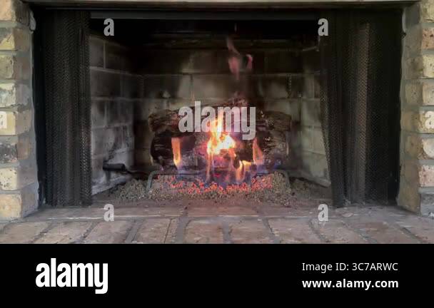A comforting scene of a crackling fireplace burning warmly in a cozy ...