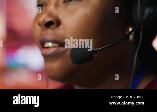 Closeup of call center employee talks in headphones mic, handling ...