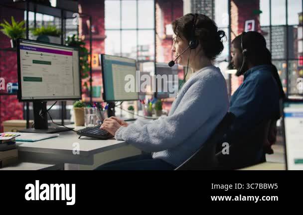 Call center team of agents wearing headset assisting customers over ...