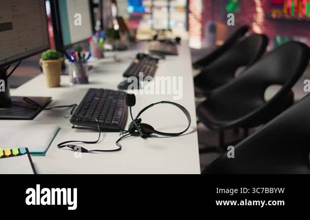 PC displays in empty call center office where unsatisfied customers call to solve technical ...