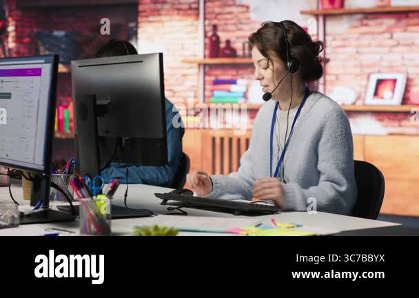 Worker providing live chat support, typing on keyboard, handling ...