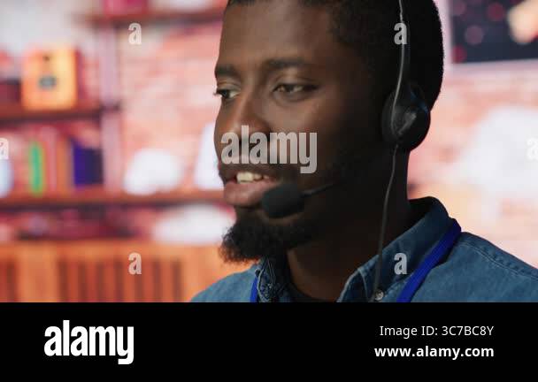 Closeup of call center agent using headphones mic to talk with ...