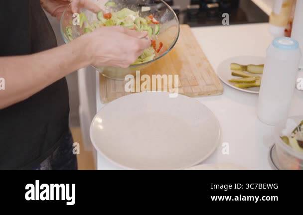 Close-Up of Person Serving Fresh Vegetable Salad onto White Plate from ...